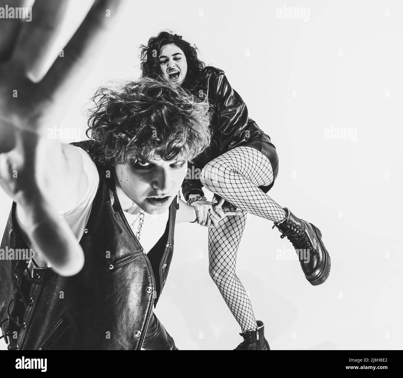 Monochrome portrait of crazy musicians, young couple wearing black ...