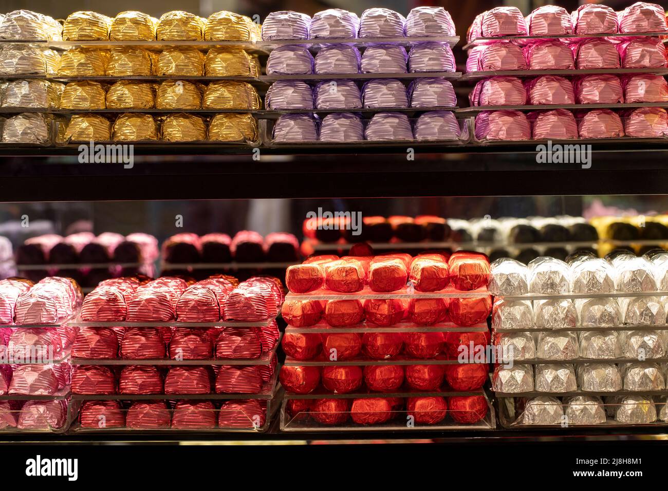 Chocolate stand. Patisserie chocolate counter. Specially coated ...