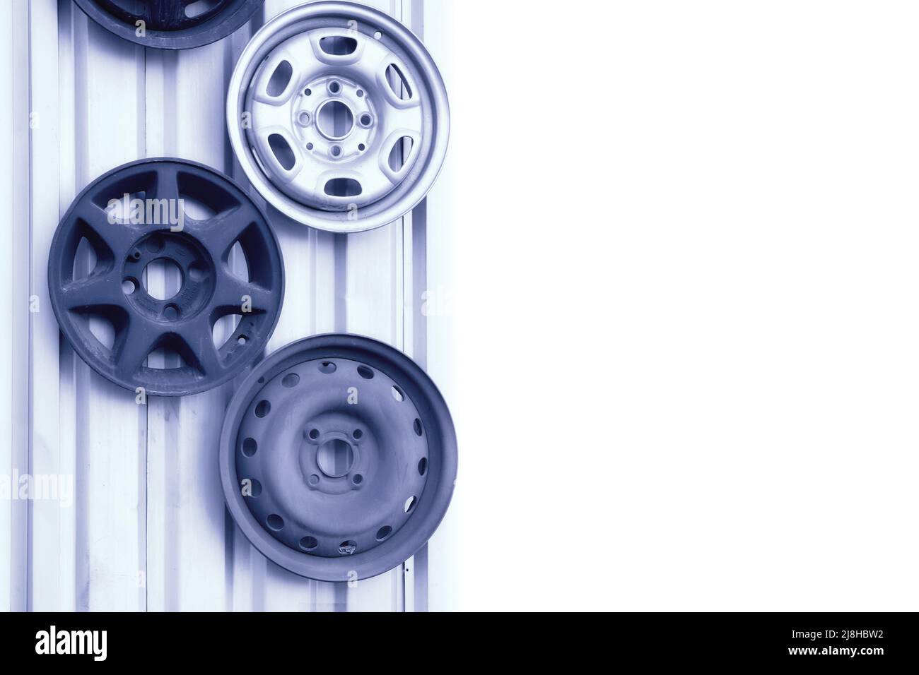 Three metal car rims hanging on the wall with space for text Stock ...