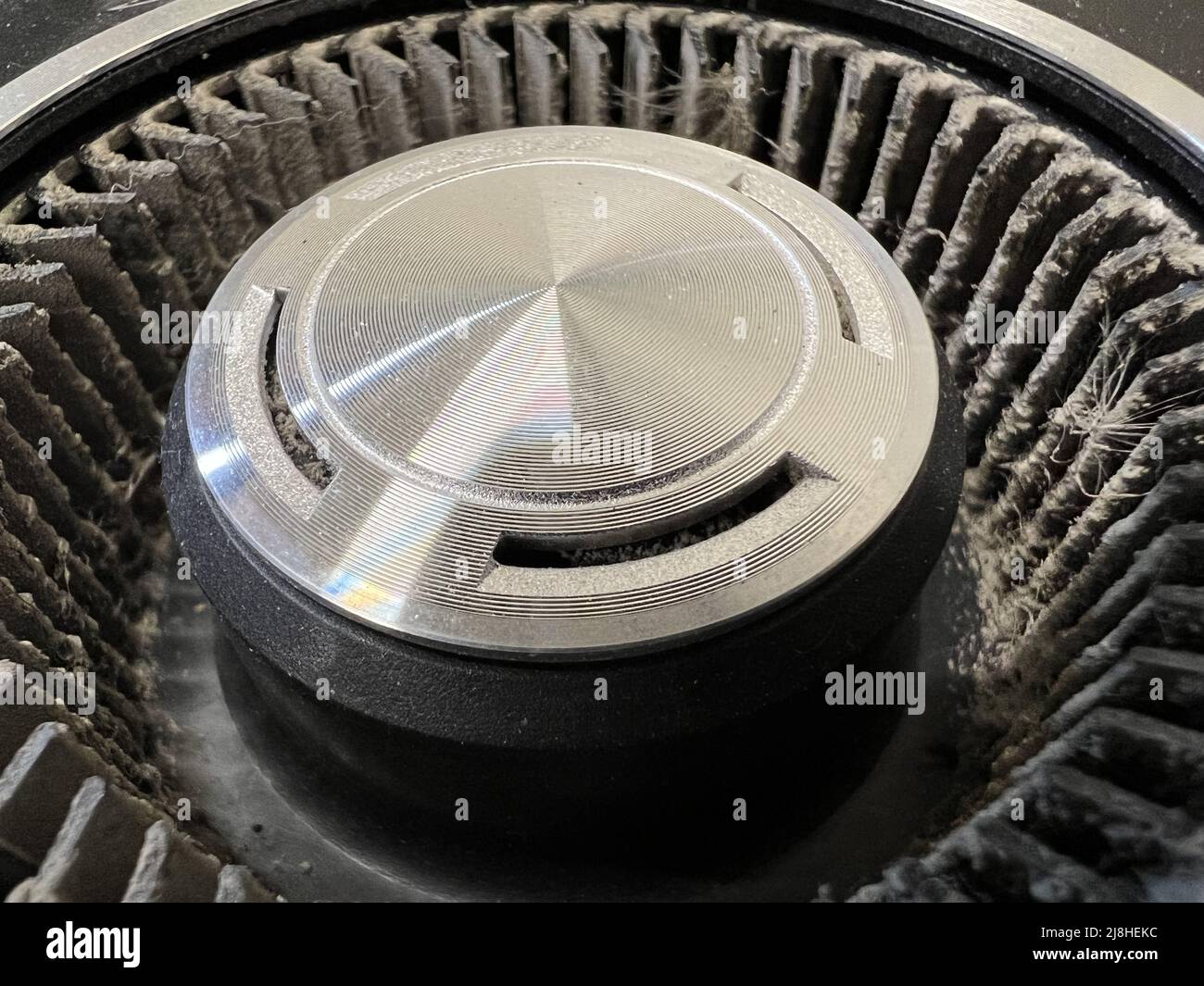 Dust is caked onto the cooling fan of an NVIDIA computer graphics card ...