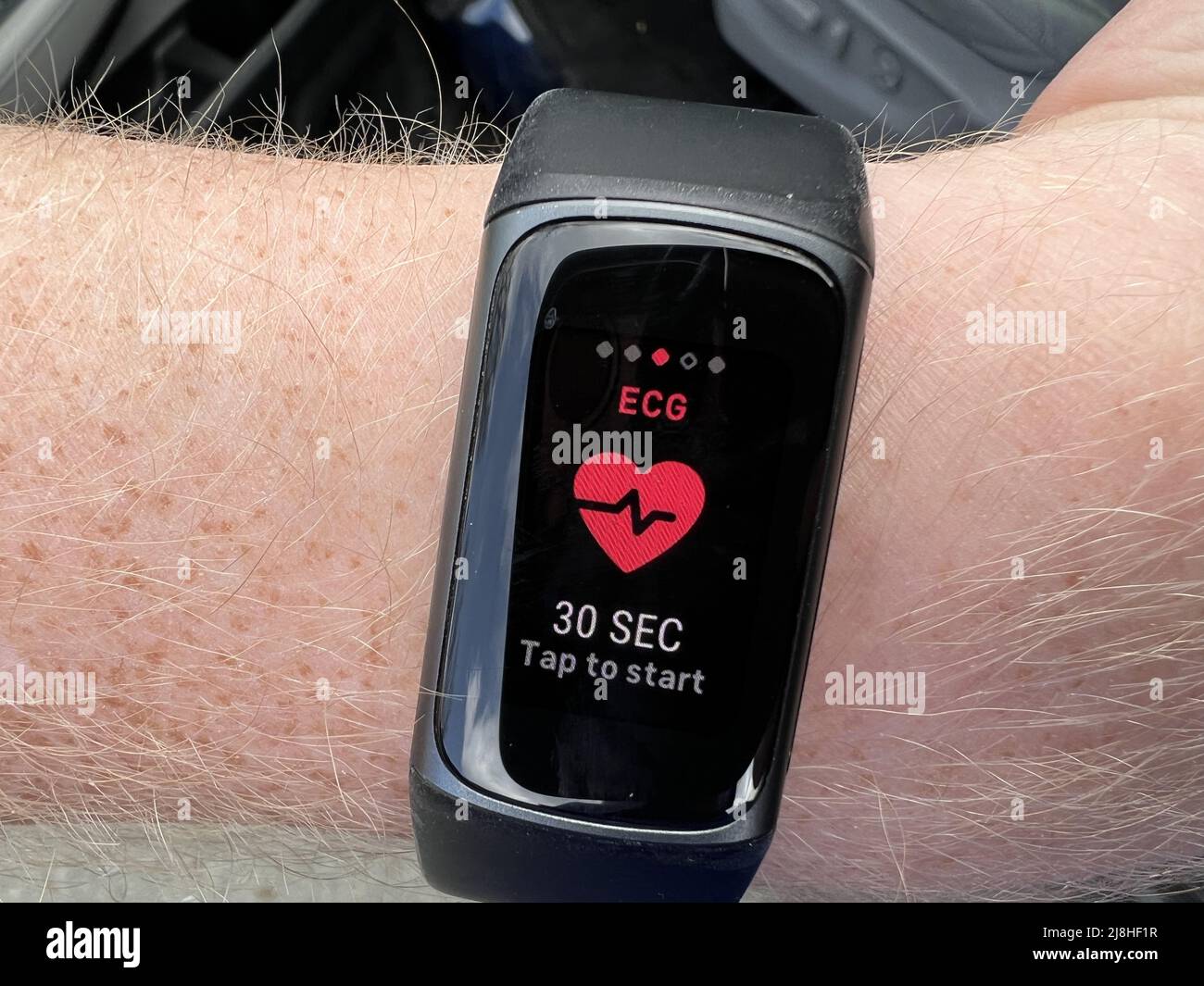 A Fitbit Charge 5 smart fitness tracker wearable is used to take an ECG ...