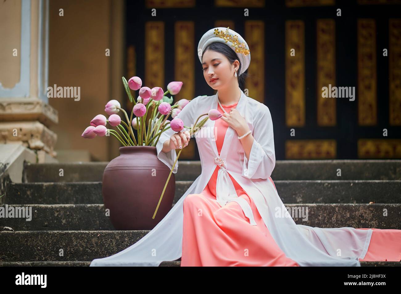 Ho Chi Minh city, Viet Nam: Vietnamese girl going to pagoda in ao dai ...