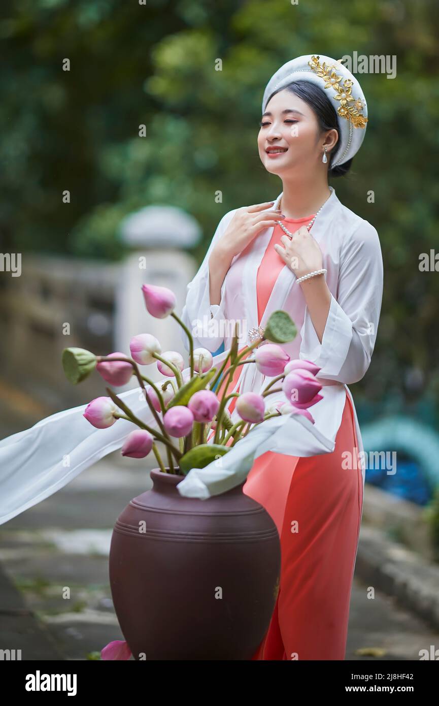 Ho Chi Minh city, Viet Nam: Vietnamese girl going to pagoda in ao dai ...