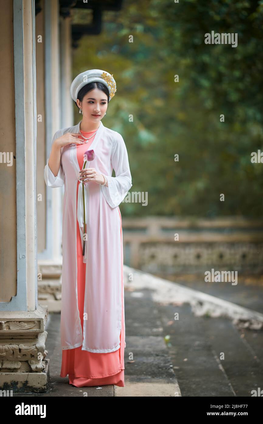 Ho Chi Minh city, Viet Nam: Vietnamese girl going to pagoda in ao dai ...