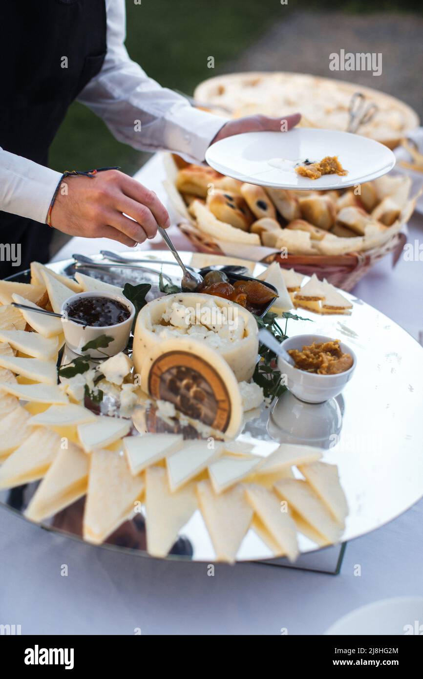 Man putting food on a plate at a wedding party Stock Photo - Alamy