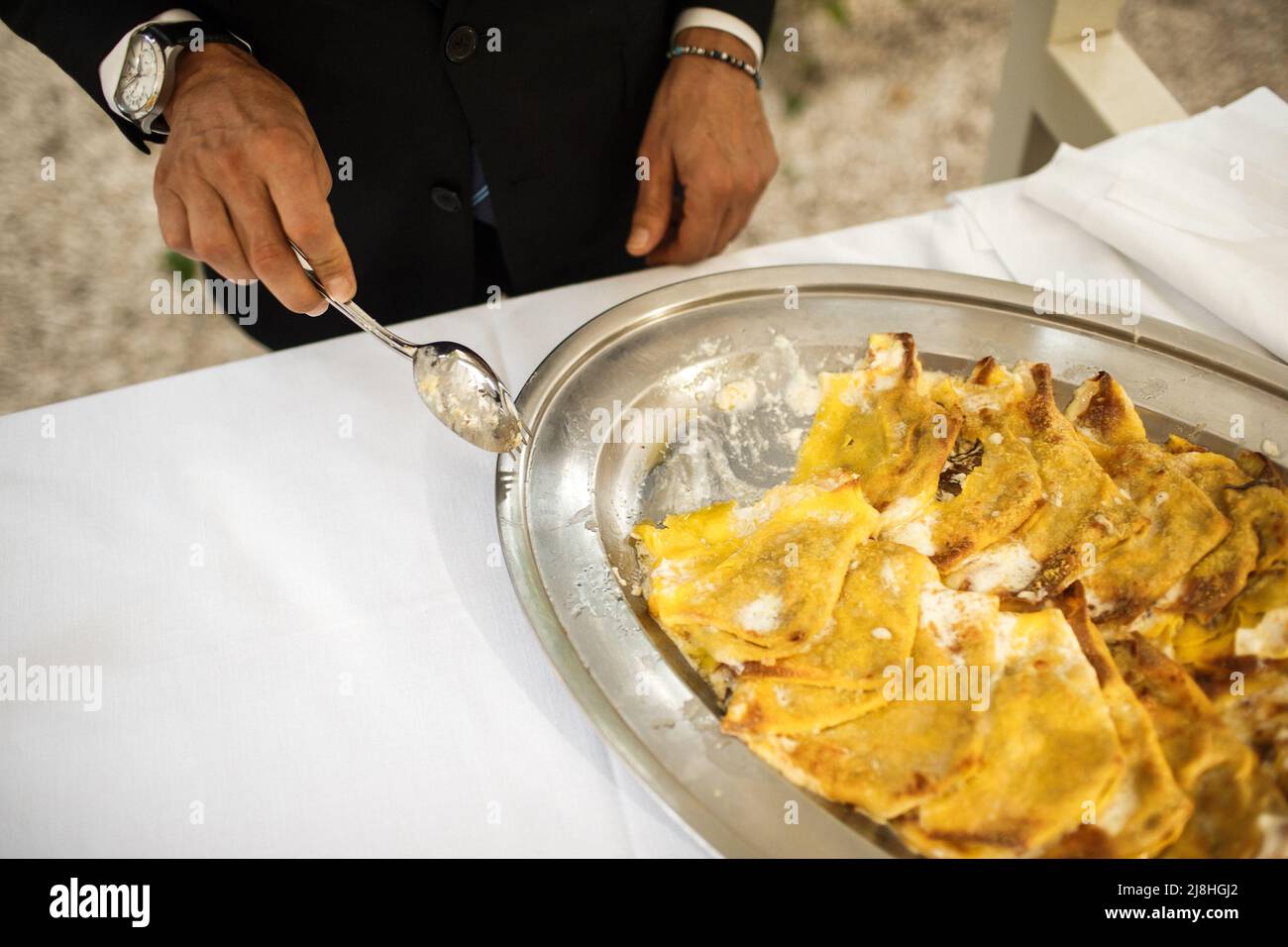 Man putting food on a plate at a wedding party Stock Photo - Alamy