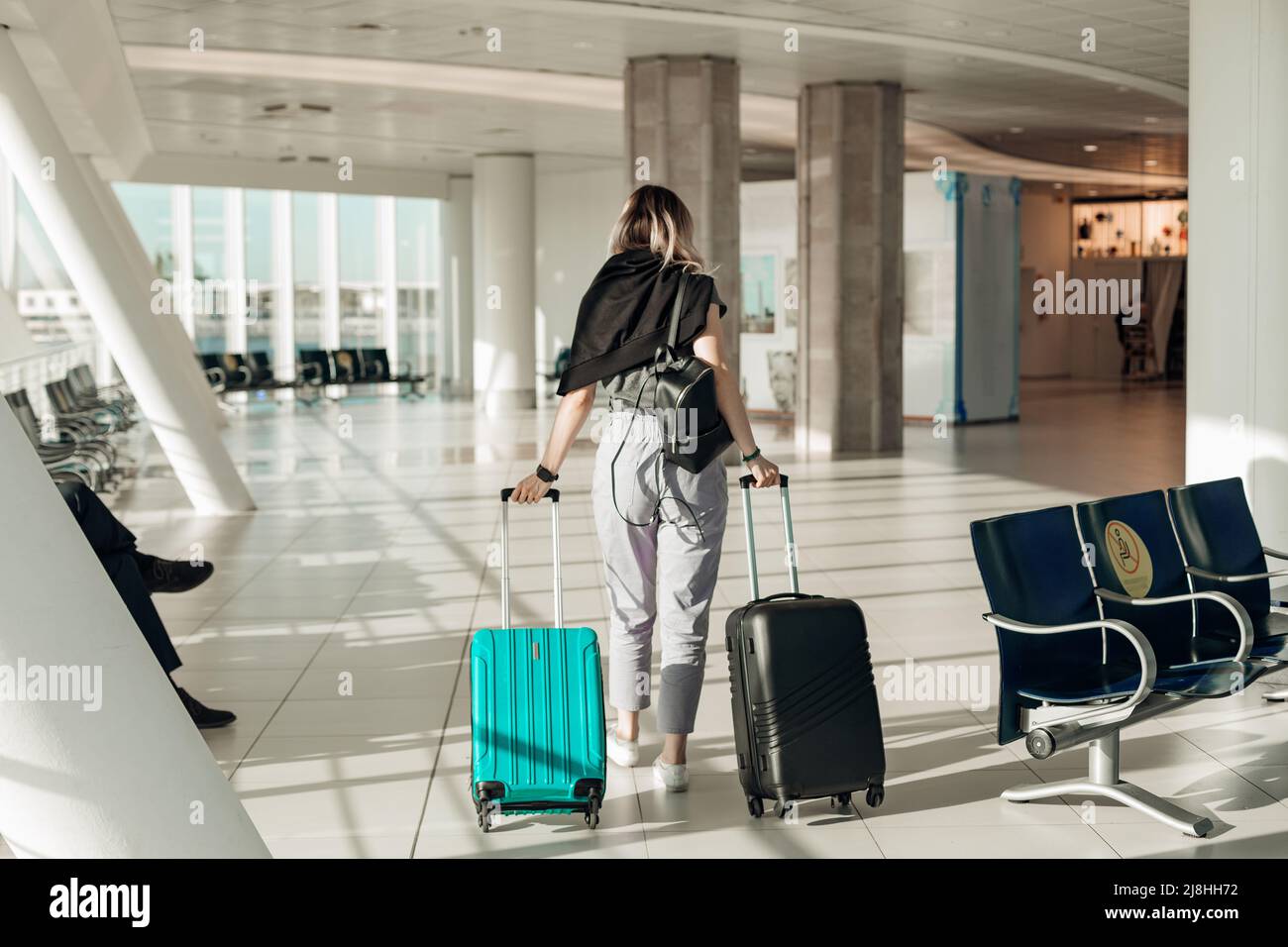 Passenger with baggage going to boarding plane in light airport with ...