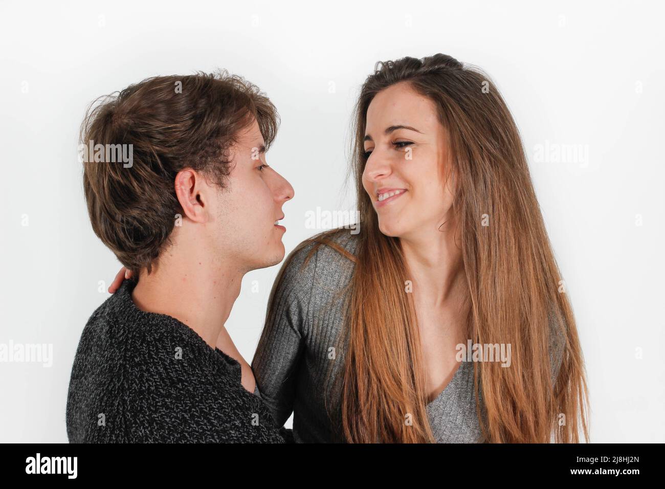 beautiful couple with long hair and winter clothes in gray and black ...