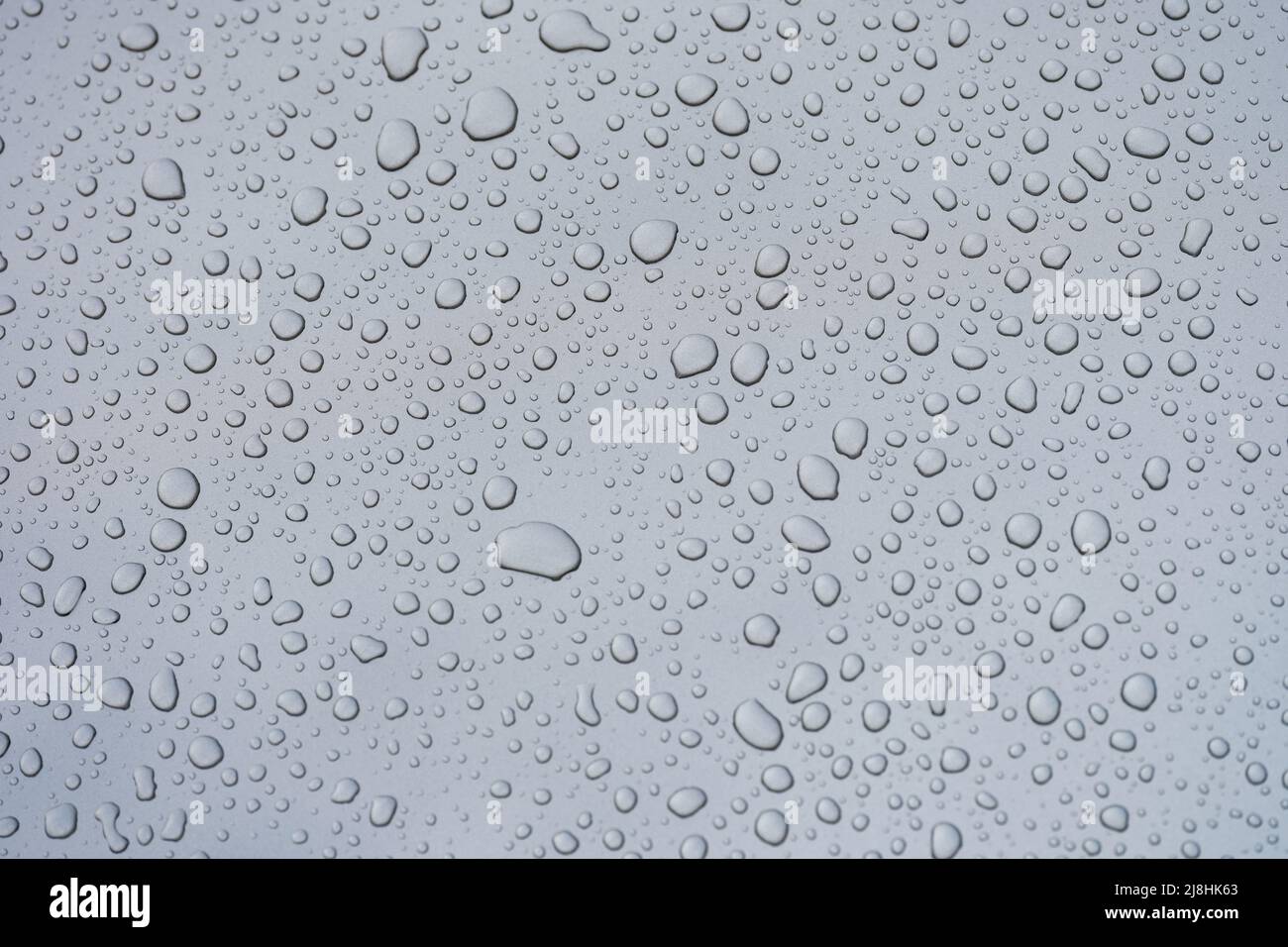 Closeup of raindrops on gray window glass texture background Stock ...