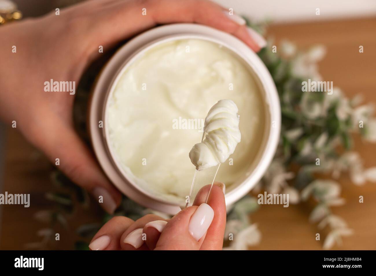 Female hands with applied hand cream by spatula. Closeup Stock Photo ...