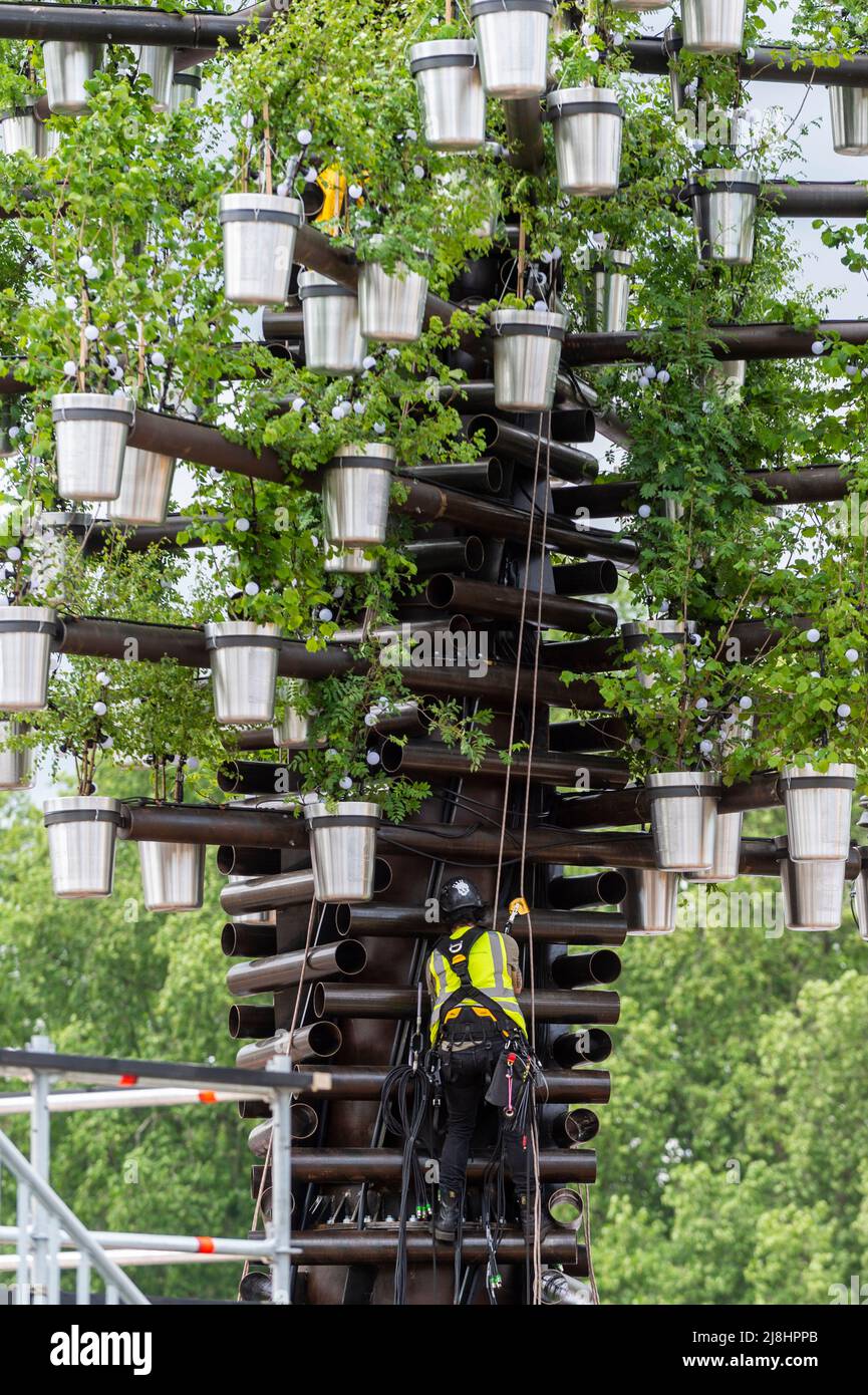 London, UK. 16 May 2022. A worker during the build of a 21-metre “Tree ...