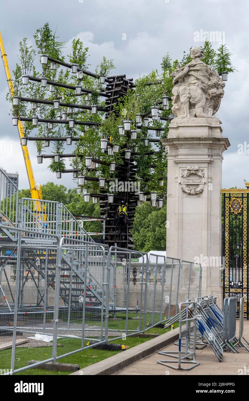 London, UK. 16 May 2022. A worker during the build of a 21-metre “Tree ...