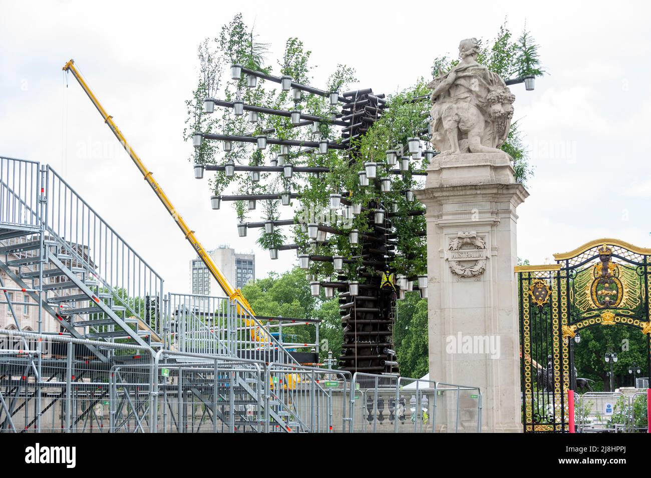London, UK. 16 May 2022. A worker during the build of a 21-metre “Tree ...