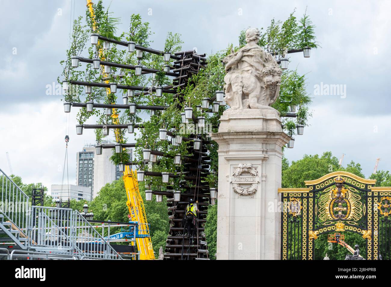 London, UK. 16 May 2022. A worker during the build of a 21-metre “Tree ...