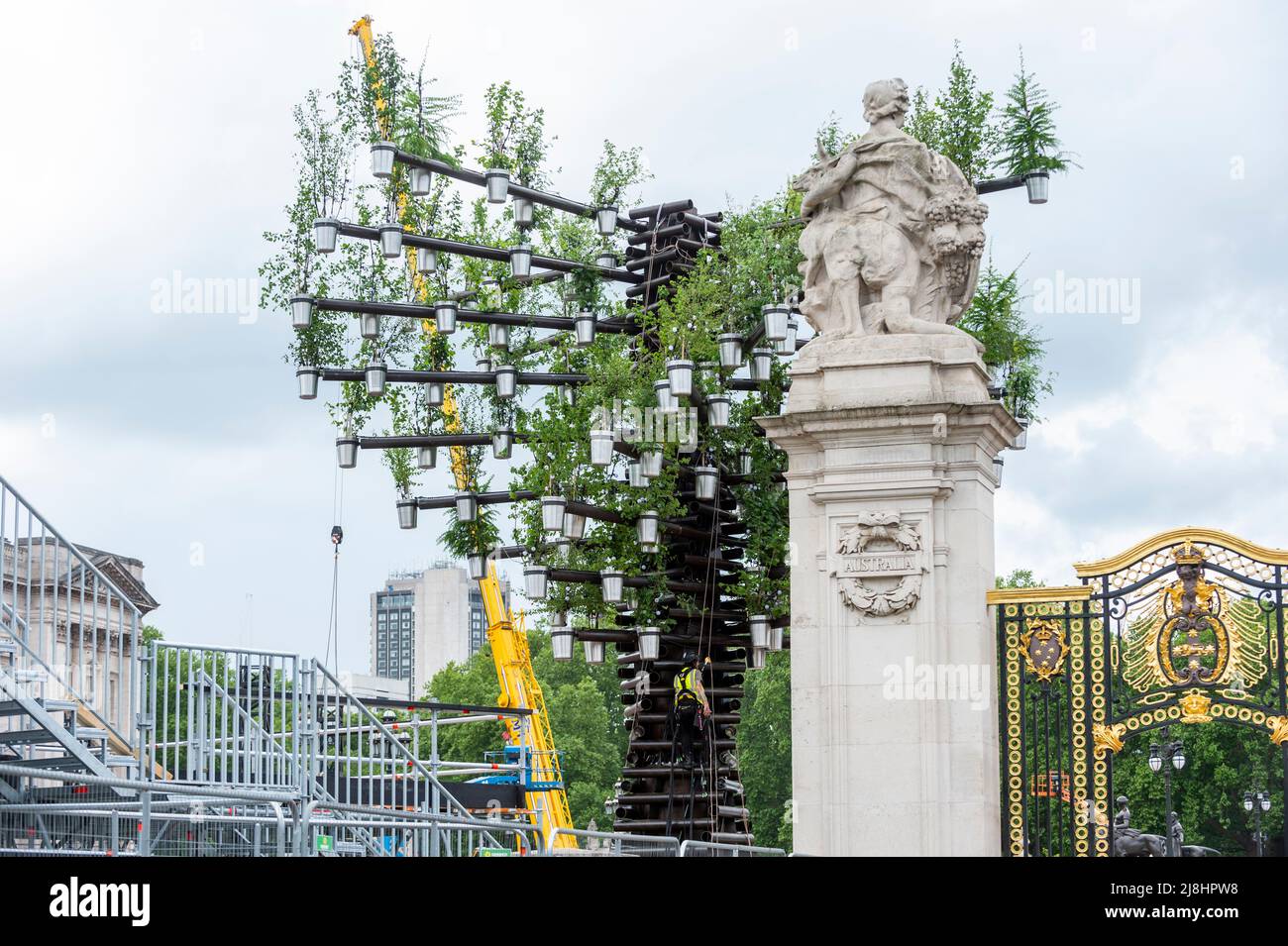 London, UK. 16 May 2022. A worker during the build of a 21-metre “Tree ...