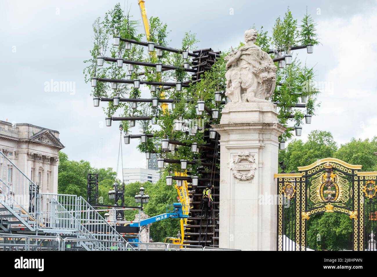 London, UK. 16 May 2022. A worker during the build of a 21-metre “Tree ...