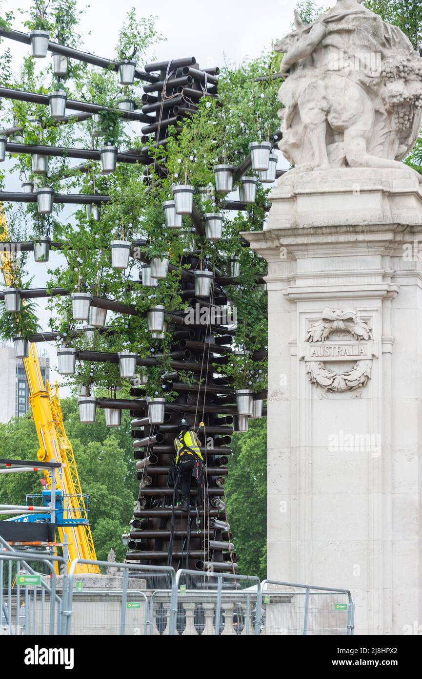 London, UK. 16 May 2022. A worker during the build of a 21-metre “Tree ...