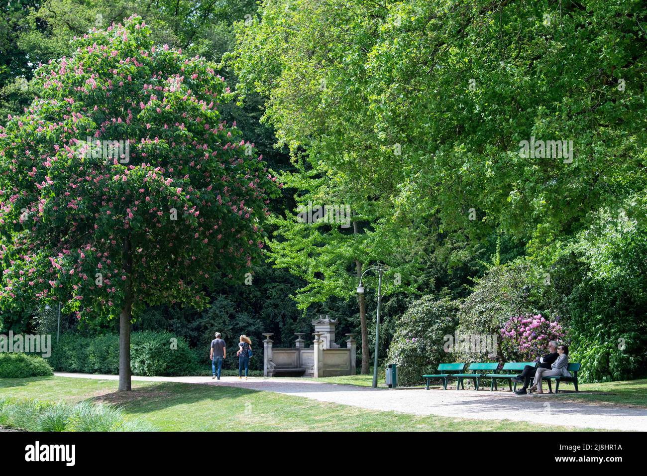 Bremen, Germany. 16th May, 2022. Two people are sitting on a bench in ...