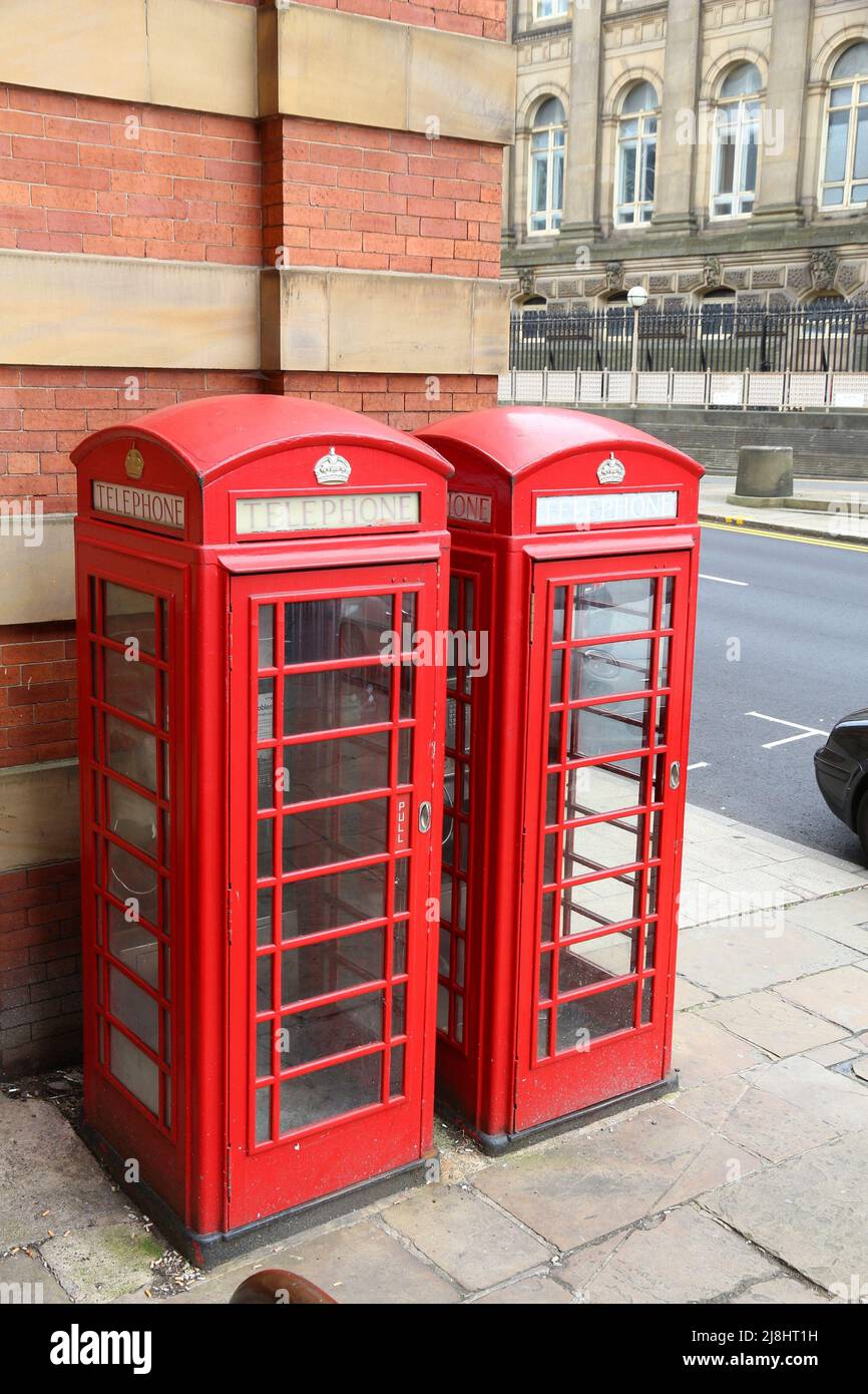 Leeds city in the UK. Red telephone booths Stock Photo - Alamy