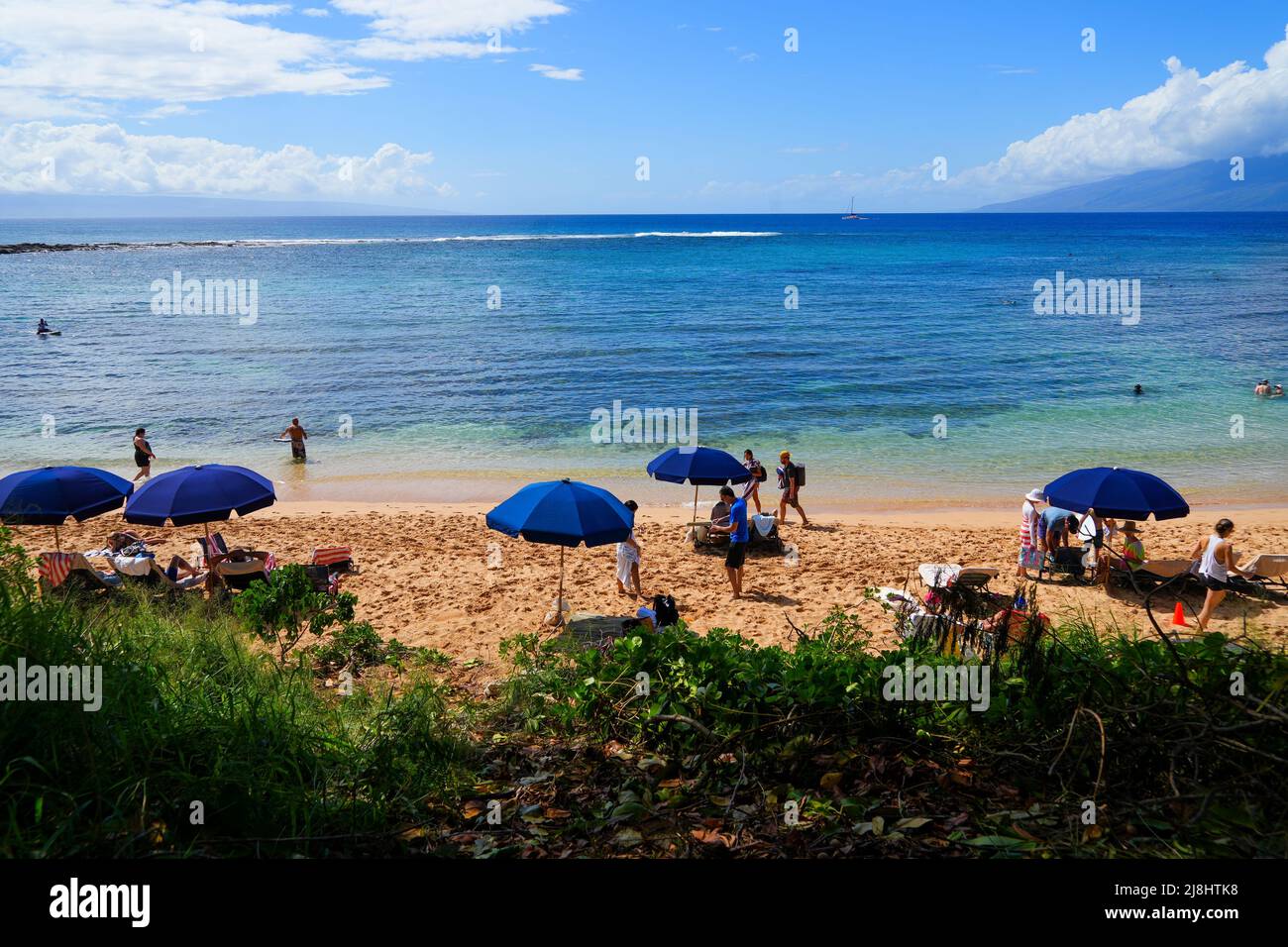 Tourists relaxing on the beach of Kapalua Bay on West Maui, Hawaii ...