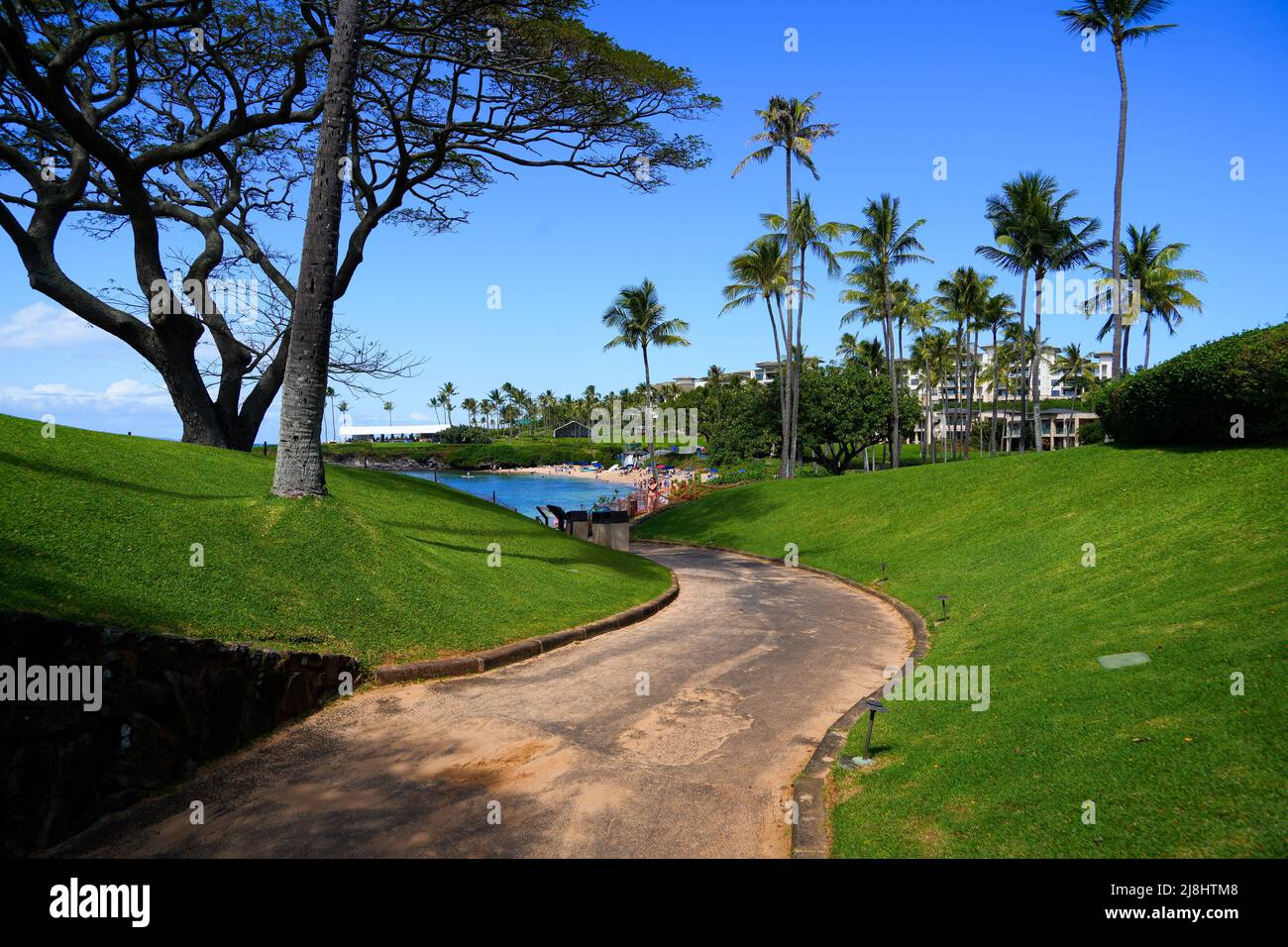 Walking path on the Kapalua Coastal Trail winding between luxury ...