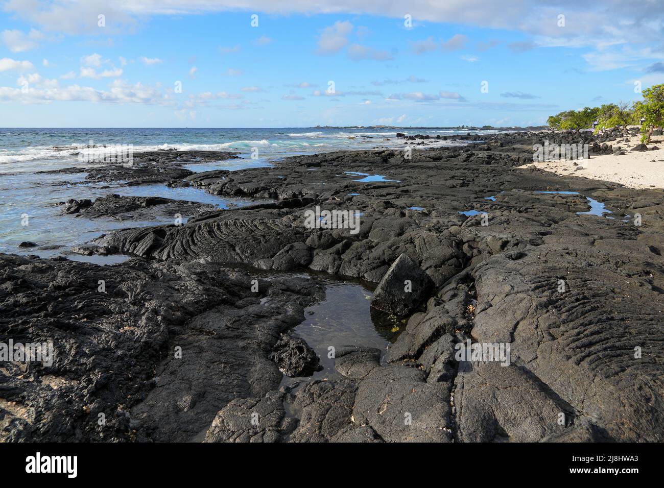 Solidified lava on the sandy O'oma Beach near Kailua-Kona in the west ...