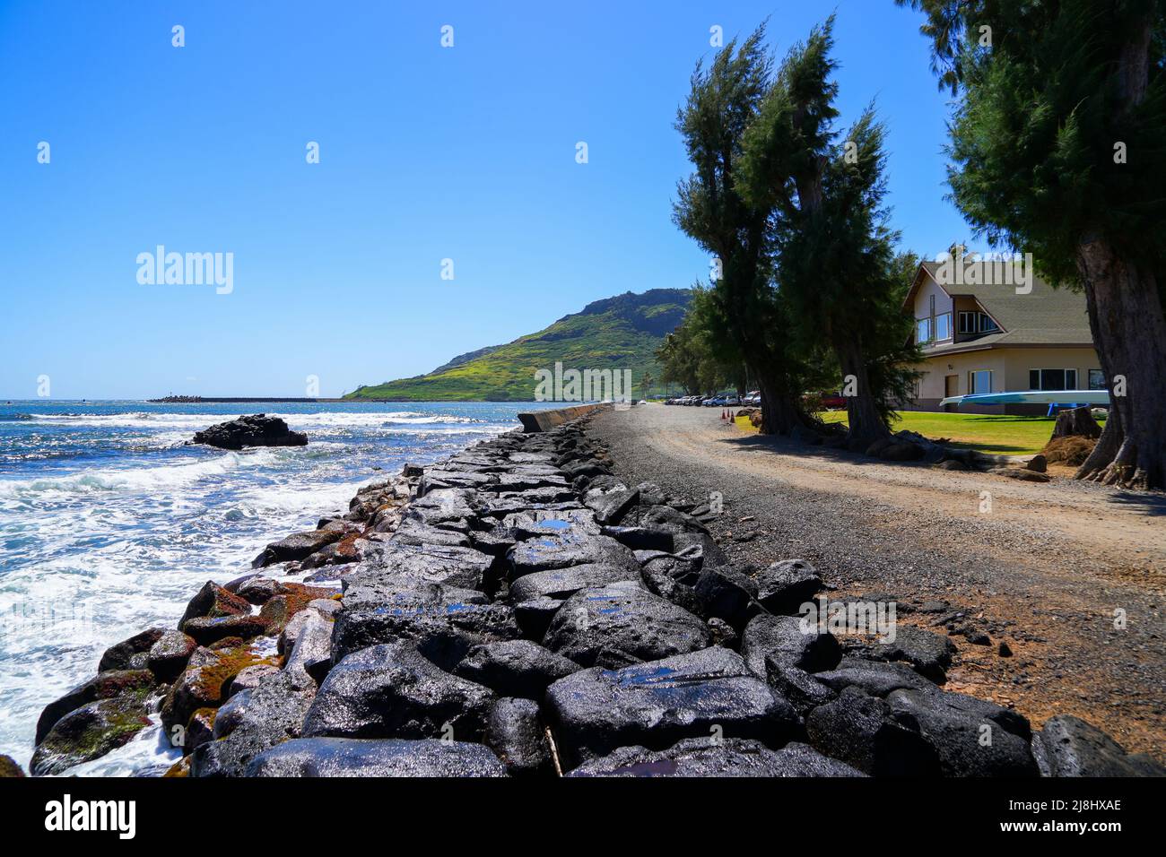 Lava rock breakwater on Kalapaki Beach on the South Shore of Kauai ...