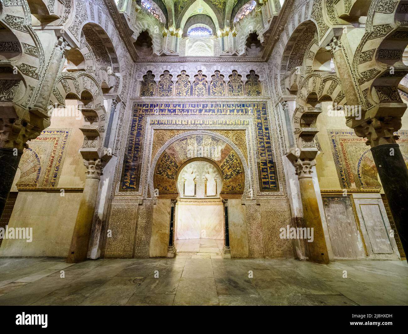 The mosaic-decorated mihrab (center) and the interlacing arches of the ...