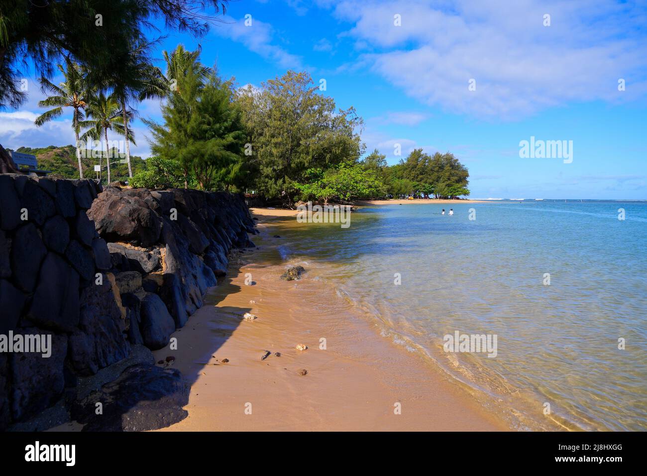 Volcanic rock road on Anini Beach on the North Shore of Kauai island in ...