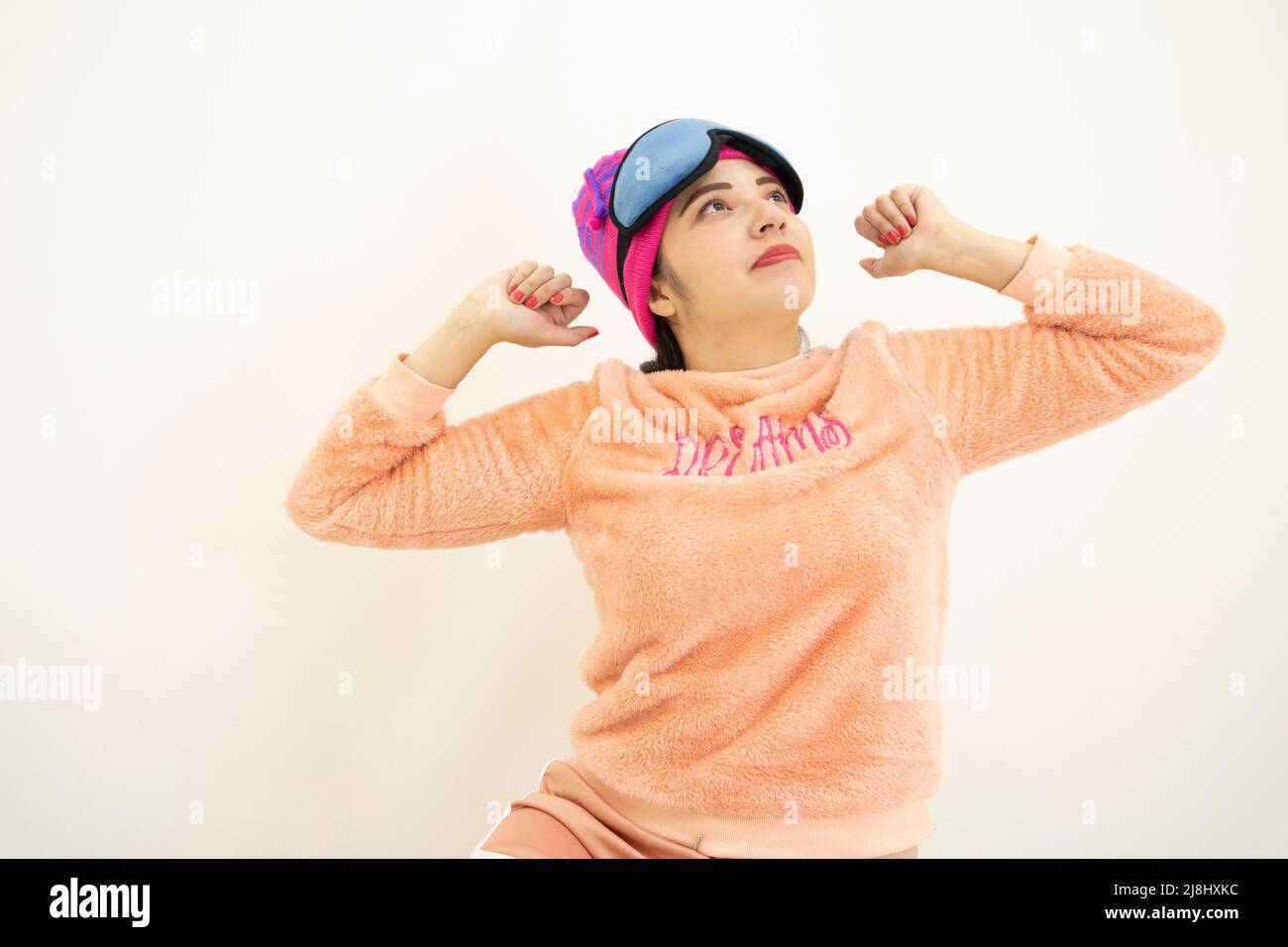 beautiful young white asian woman wearing a pink pajamas, night cap and ...