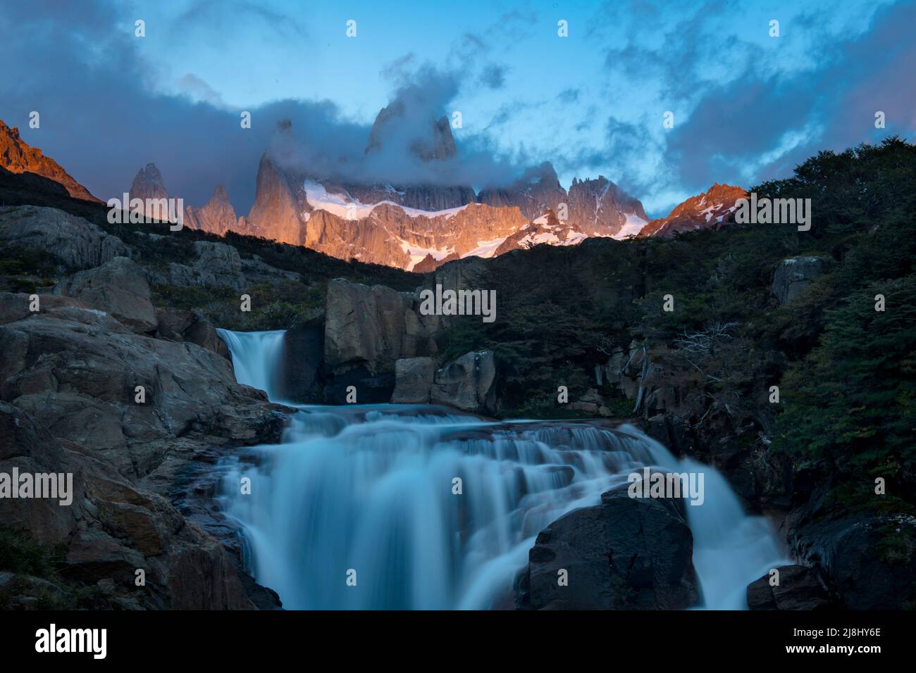 A big waterfall cascades before the Fitzroy massif, the iconic p Stock ...