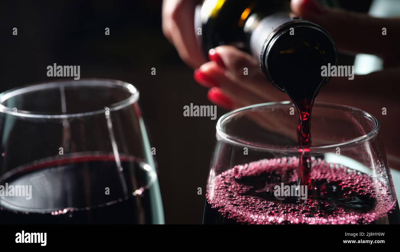 Woman pouring red wine into glass, tasting and degustation Stock Photo ...