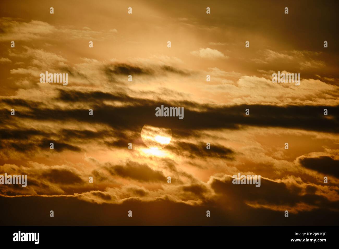 Evening dramatic sky with clouds during sunset. The sun sets behind dark clouds Stock Photo - Alamy