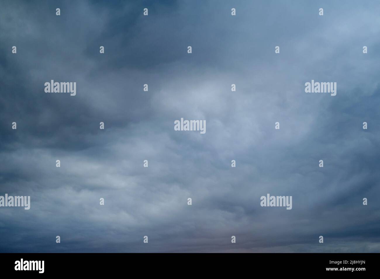 Dark rain clouds in the evening sky. Dramatic sky with an coming cloudy ...