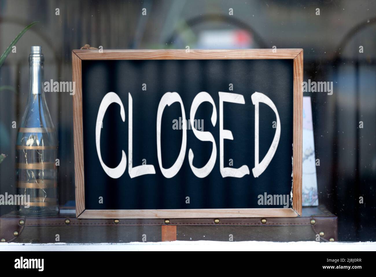 Blackboard in the windowcase of a restaurant with written in it "Closed ...