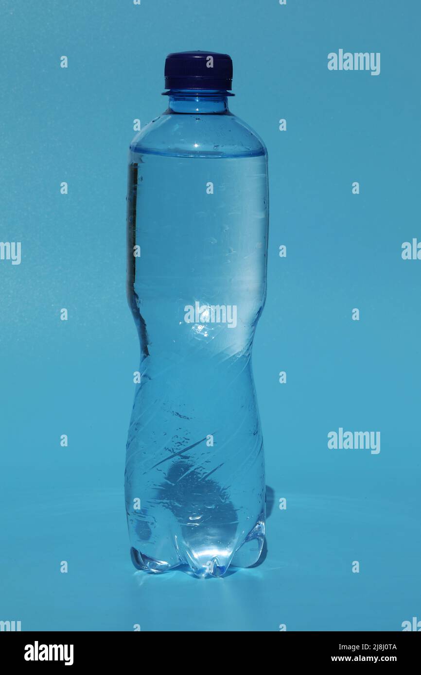 bottle of cold water on the blue background Stock Photo - Alamy