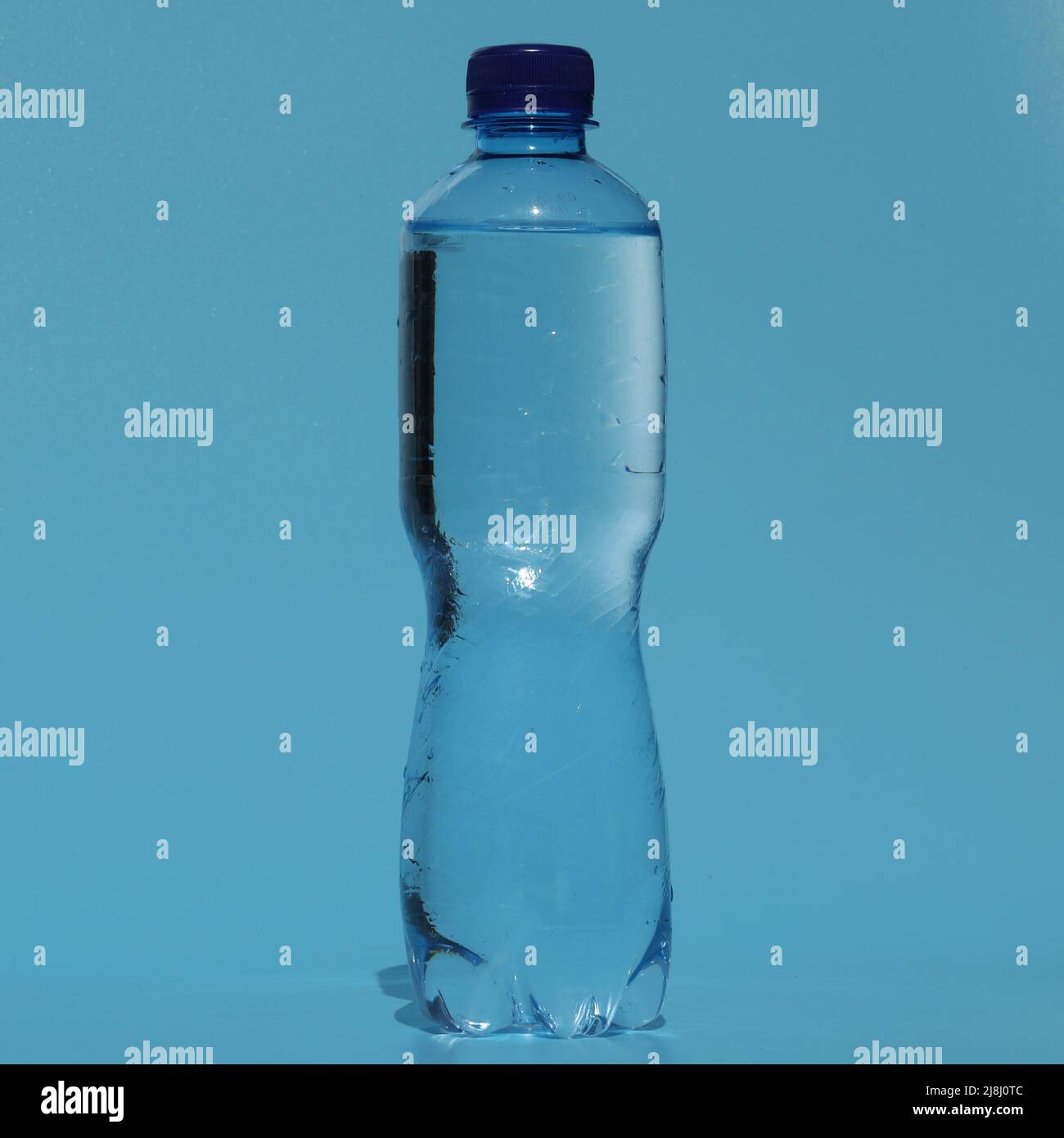 bottle of cold water on the blue background Stock Photo - Alamy