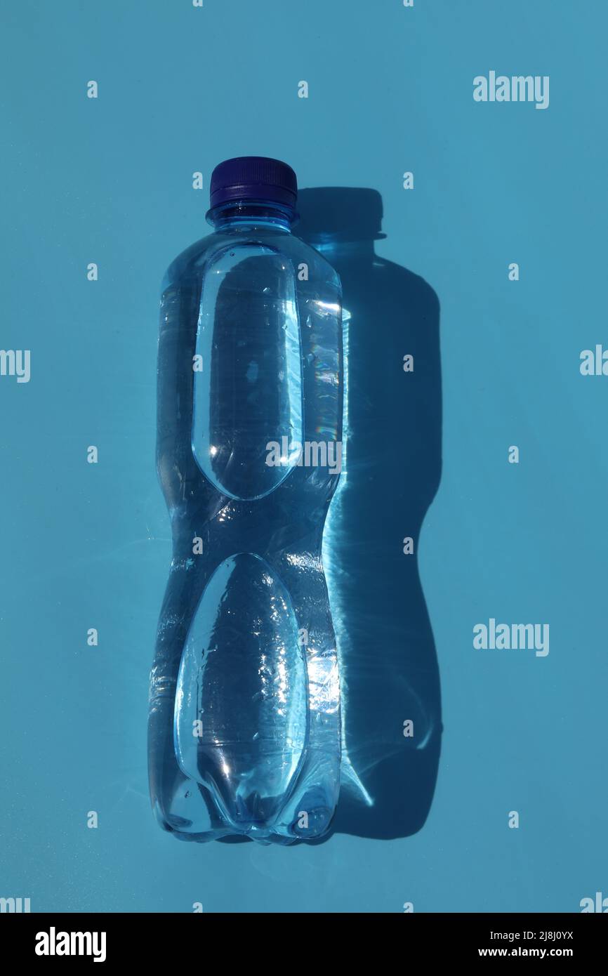 bottle of cold water on the blue background Stock Photo - Alamy