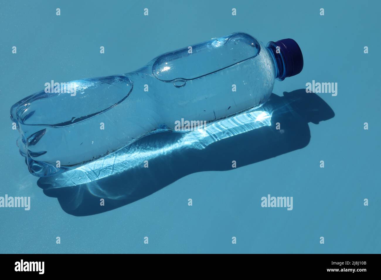 bottle of cold water on the blue background Stock Photo - Alamy
