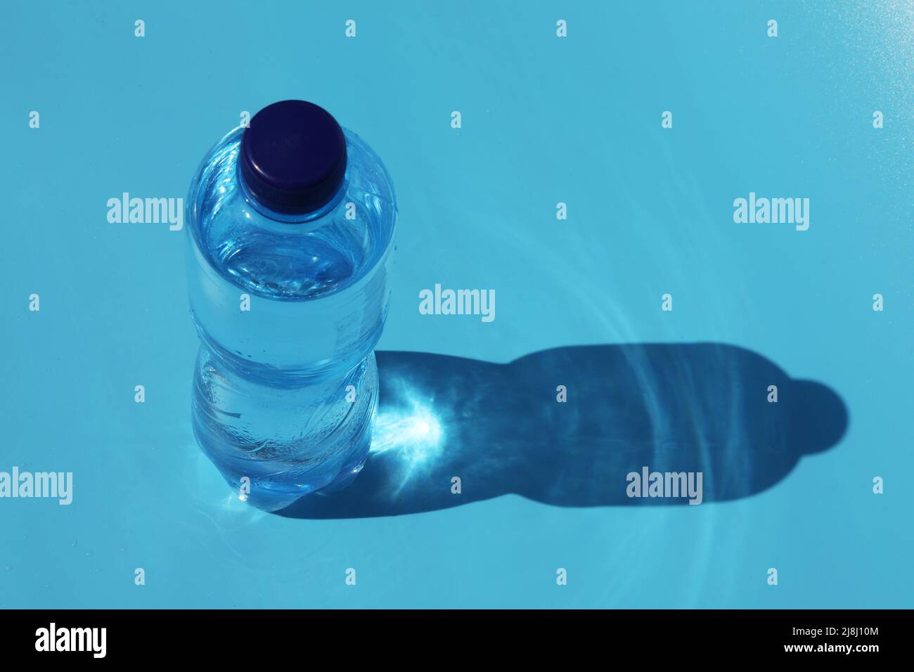 bottle of cold water on the blue background Stock Photo - Alamy