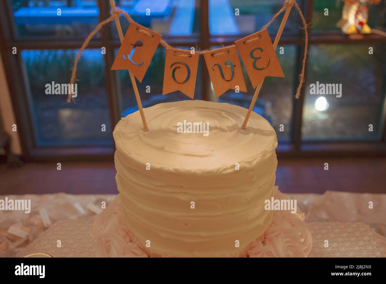 LOVE decorative sign cake topper, indoor, dim lighting Stock Photo - Alamy