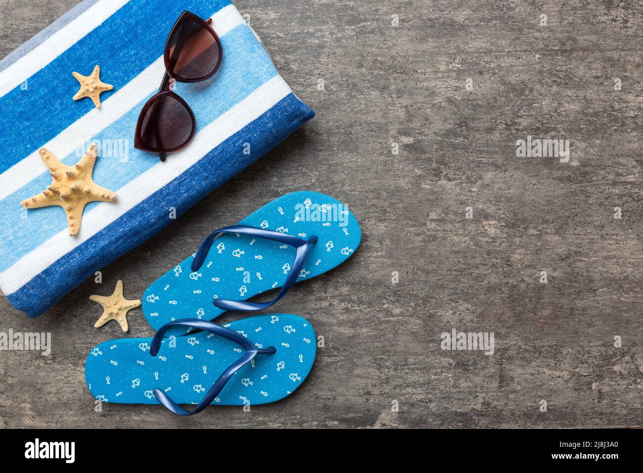 Summer travel concept. Flip flops, sunglasses and starfish on white ...