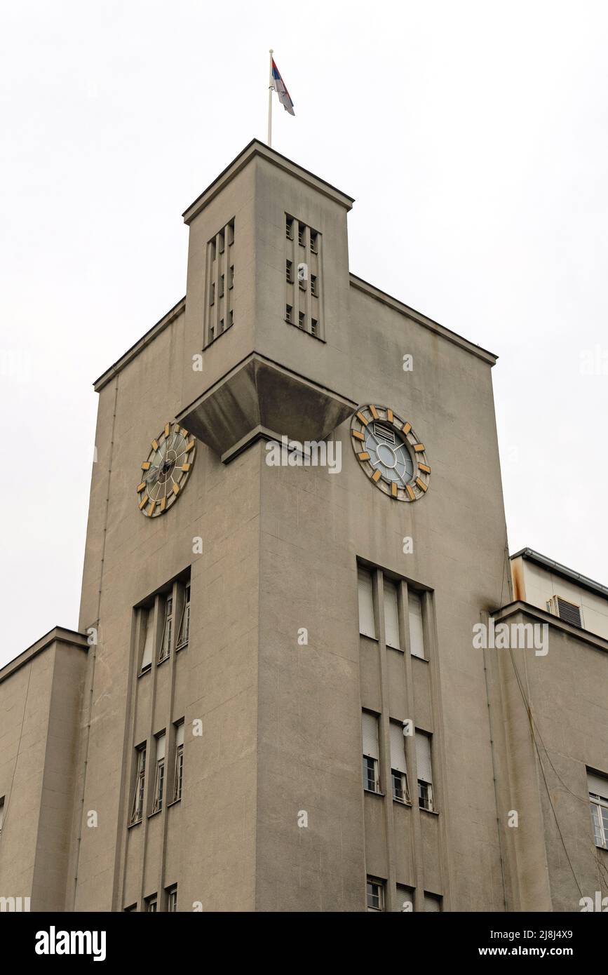 Art Deco Clock at Tall Tower With Flag at Top Stock Photo - Alamy