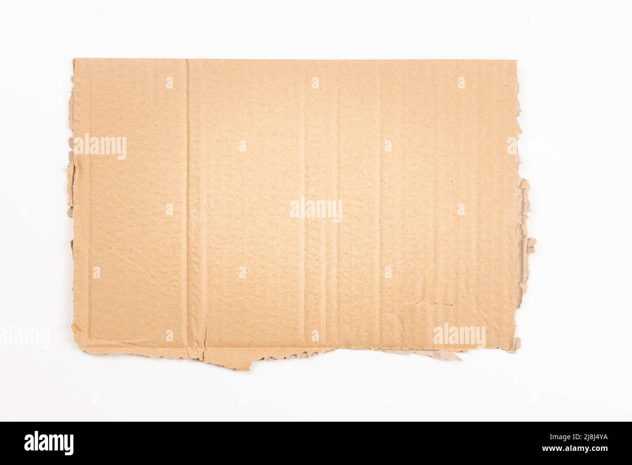 Piece of brown corrugated cardboard isolated on white background ...