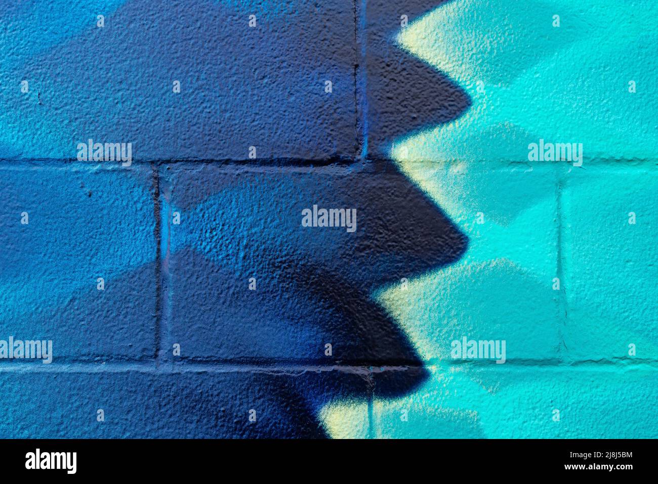 Colorful painted block wall in city alley Stock Photo - Alamy