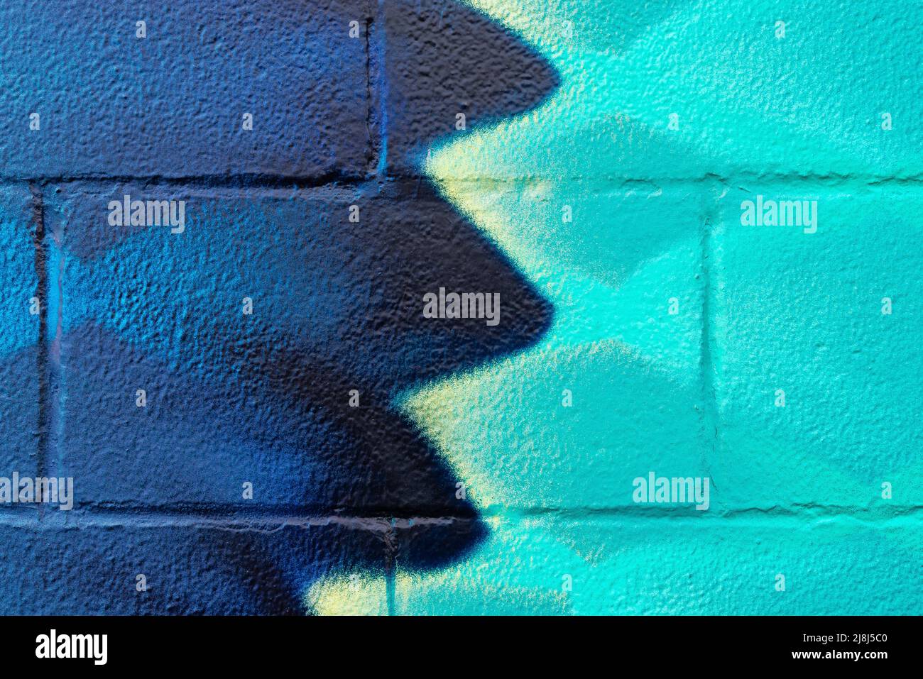Colorful painted block wall in city alley Stock Photo - Alamy