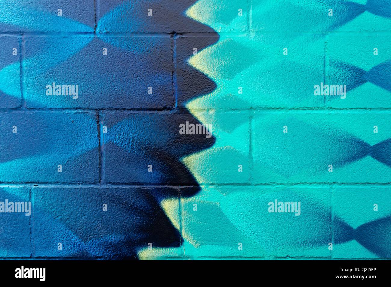 Colorful painted block wall in city alley Stock Photo - Alamy