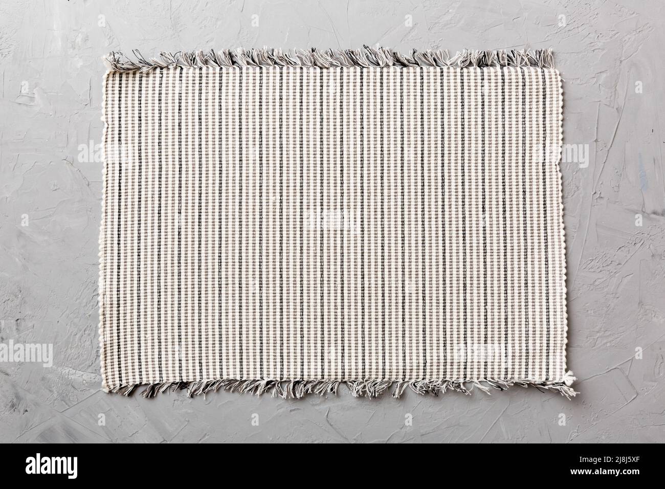 Top view of grey tablecloth for food on cement background. Empty space ...
