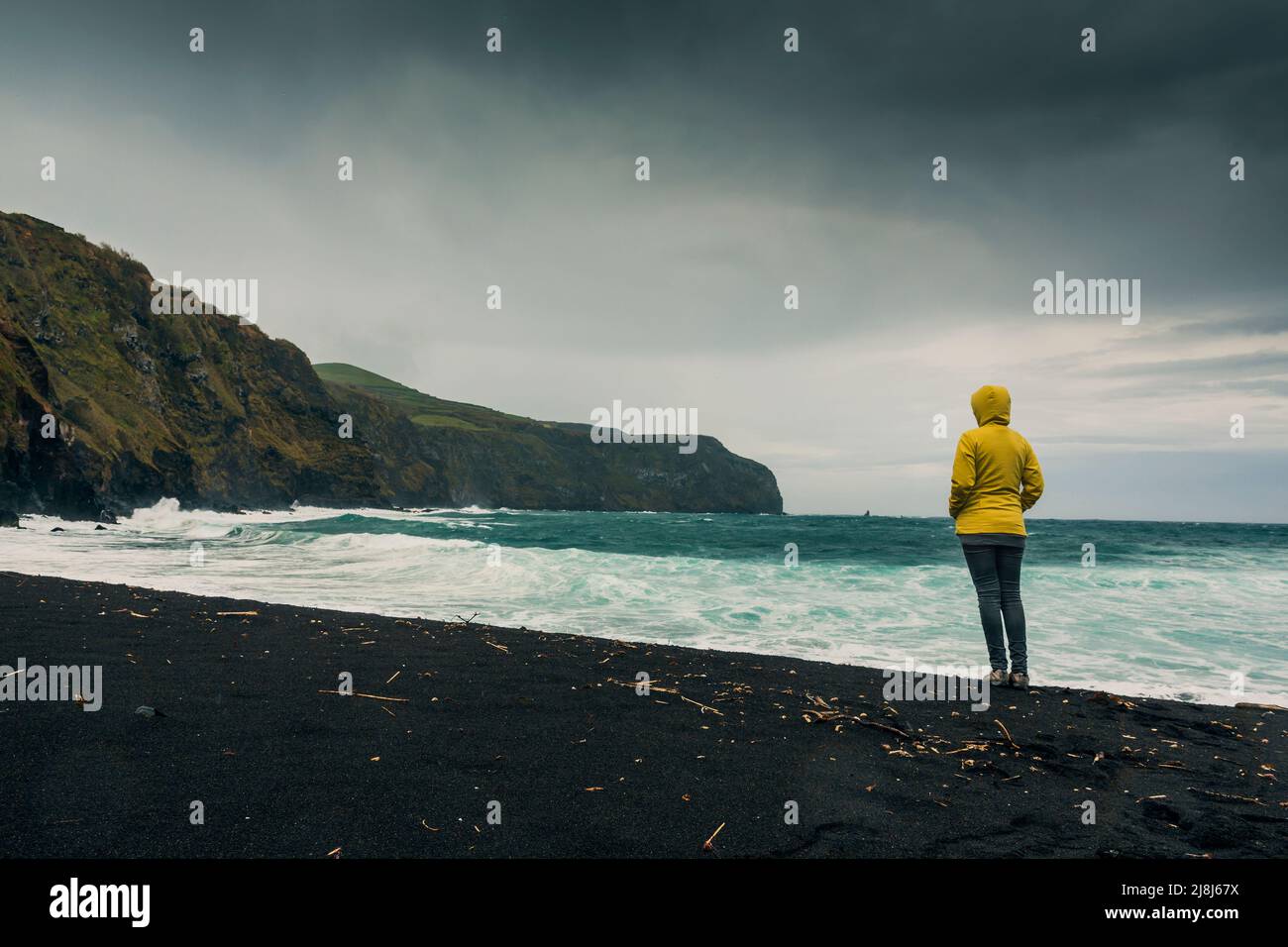 Woman walking alone in a wild beach Stock Photo - Alamy
