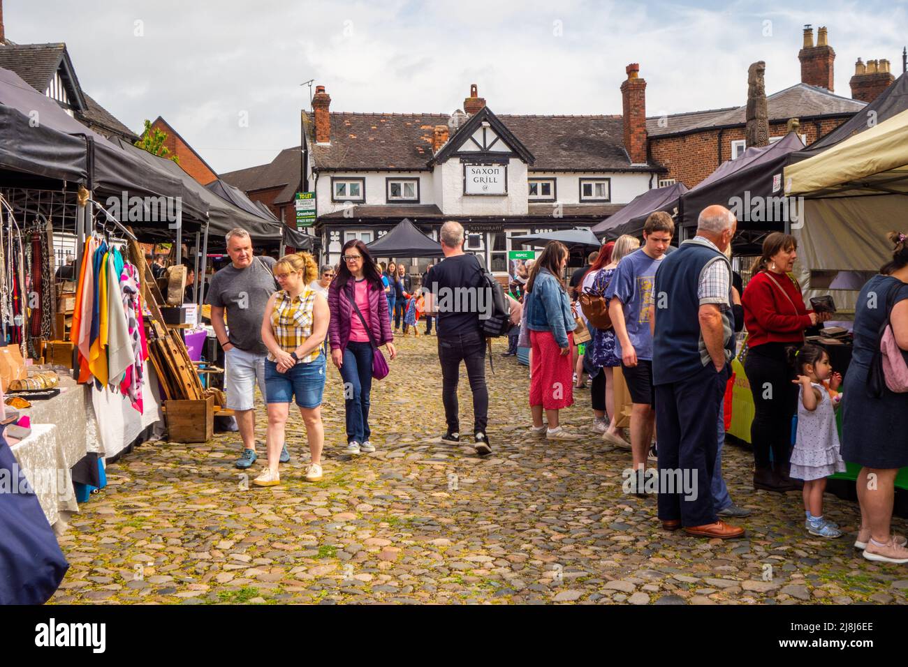 People at the farmers and makers market around the cobbled market ...